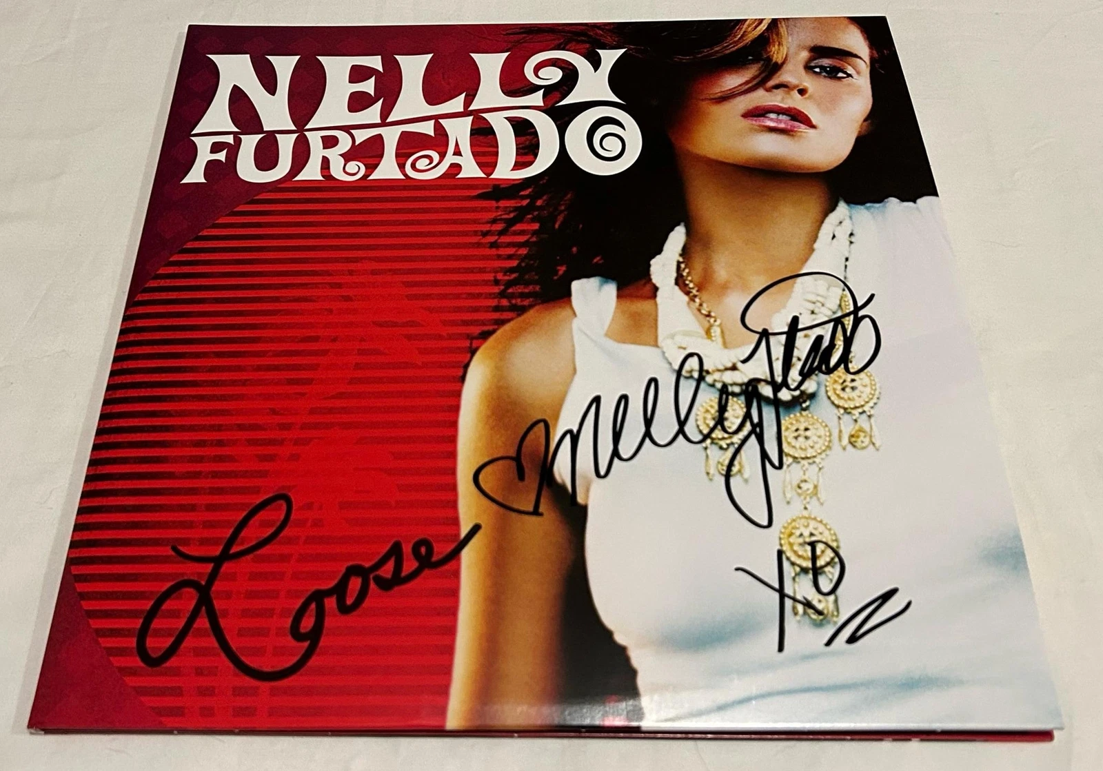NELLY FURTADO SIGNED LOOSE VINYL RECORD JSA | Autographia