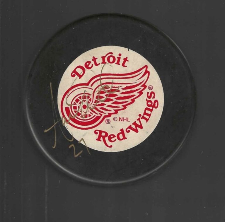 Aaron Ward Signed Detroit Red Wings Trench Puck | Autographia
